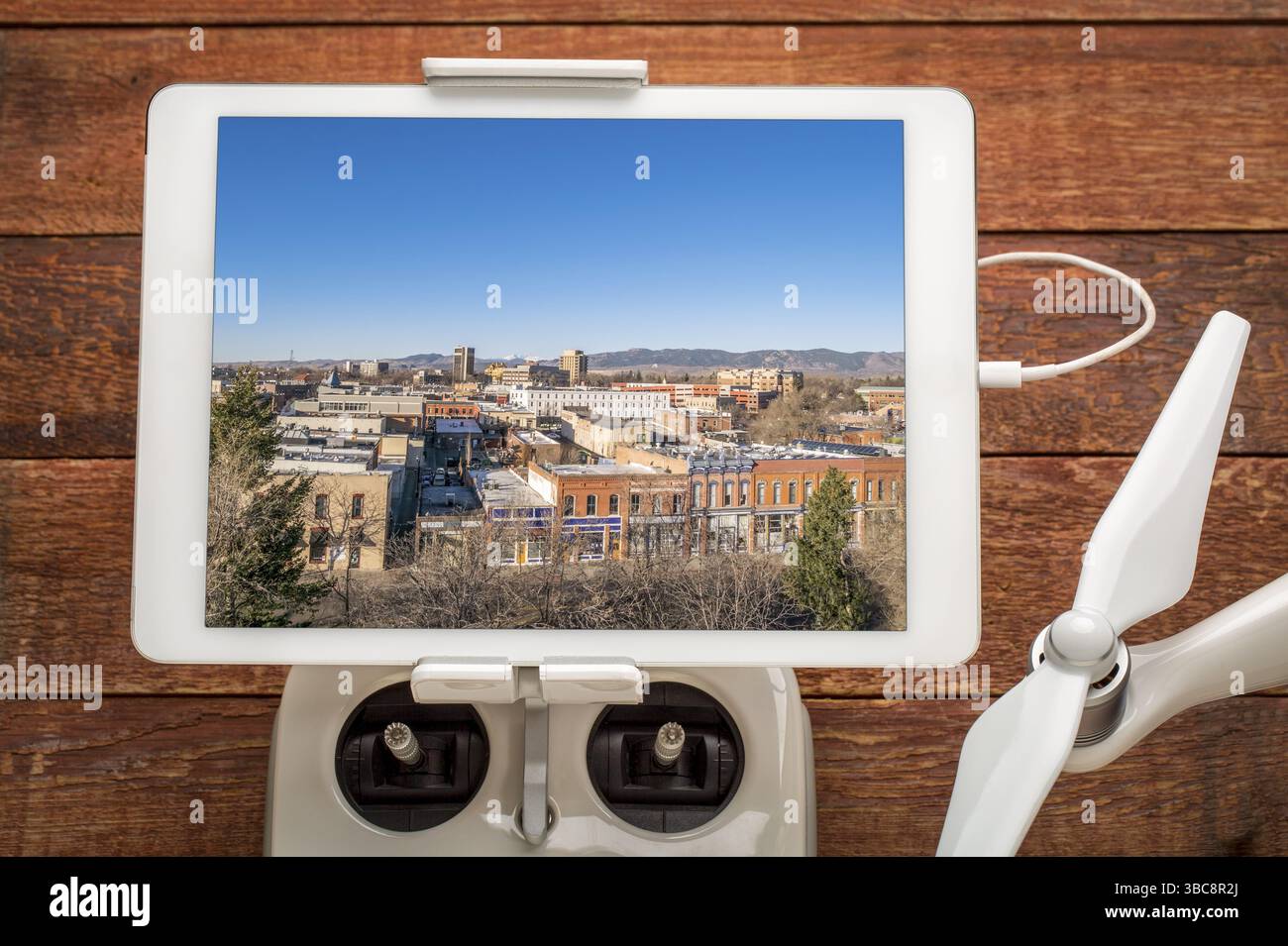 Downtown of Fort Collins - reviewing aerial image on a digital tablet ...