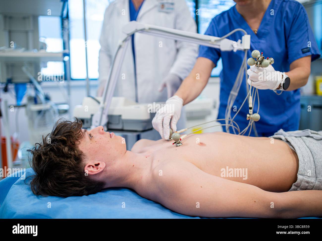 Preoperative EKG examination of teenage patient in hospital setting ...