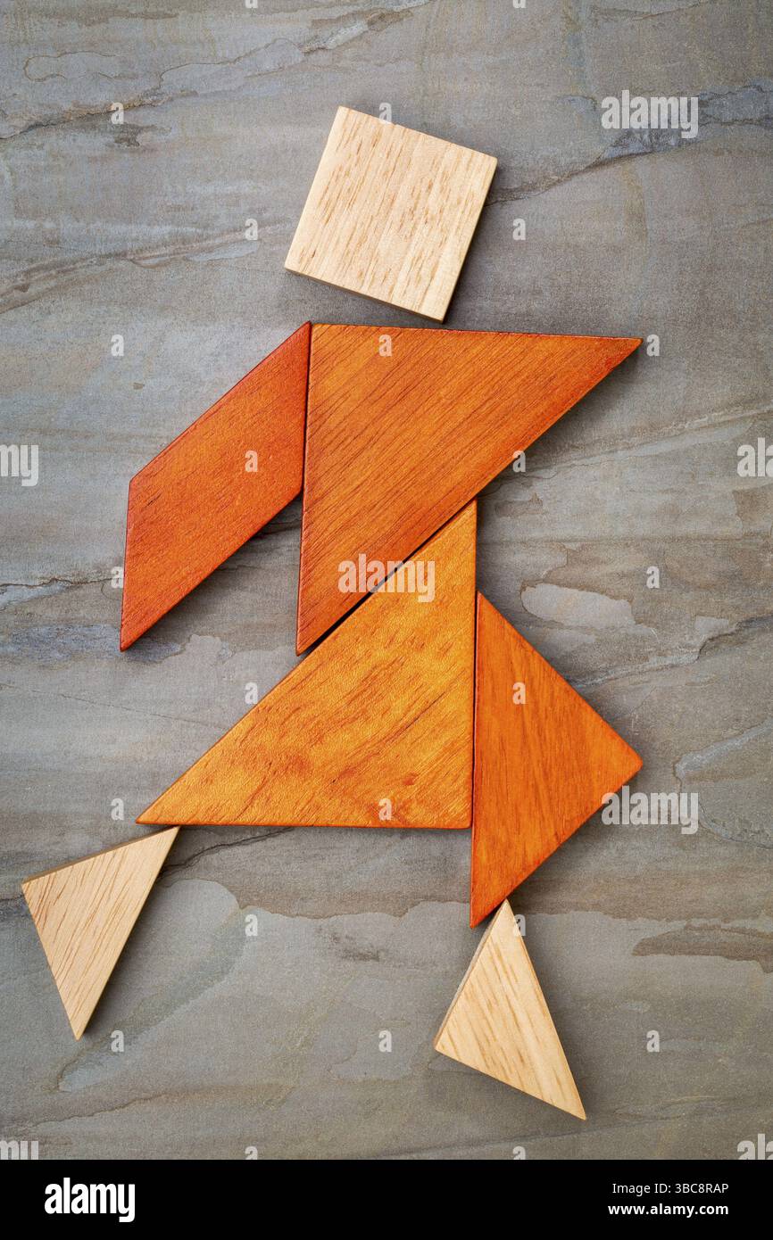Abstract of a dancing or walking figure built from seven tangram wooden ...