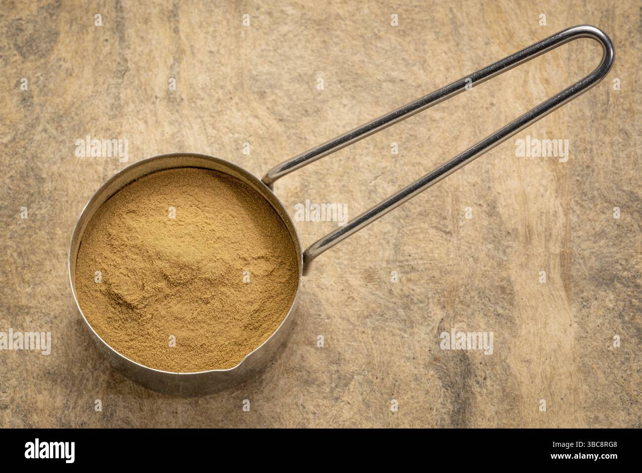 Green coffee beans powder - metal measuring scoop against brown ...