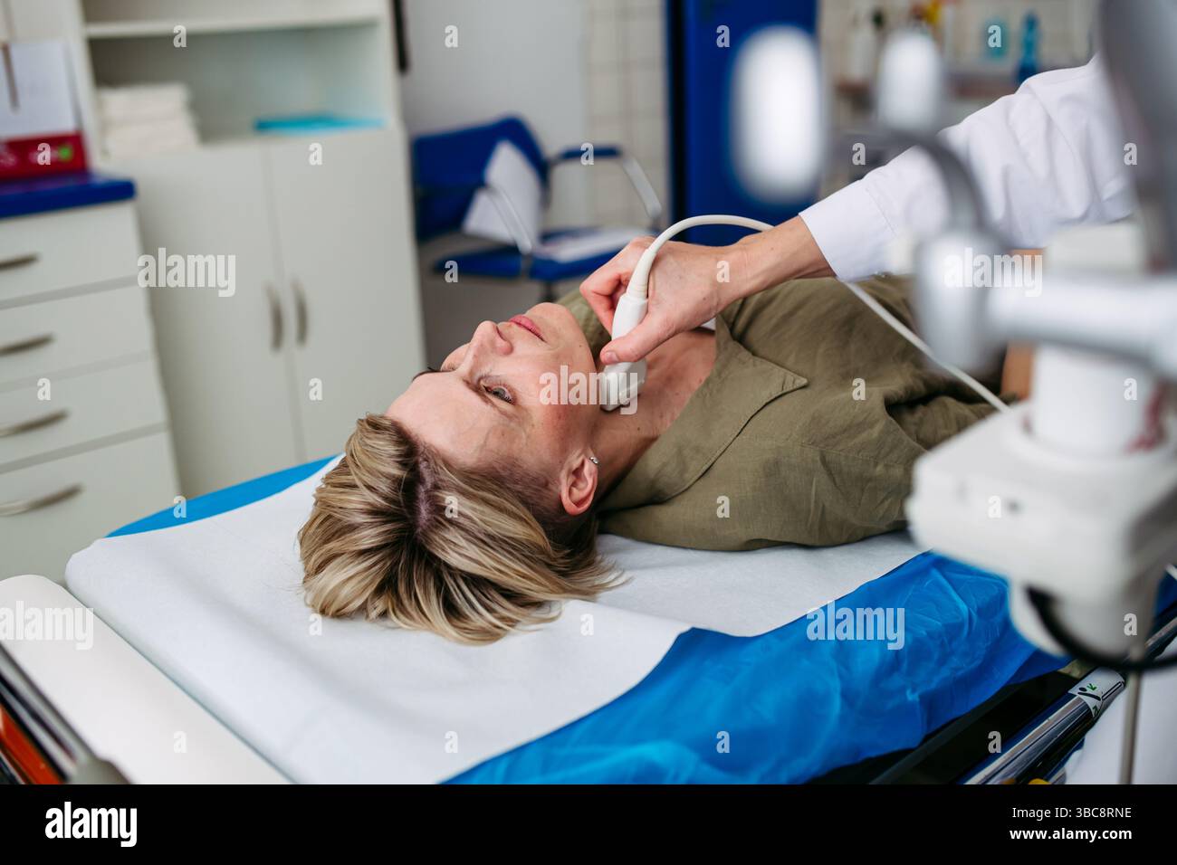 Woman undergoing ultrasound check up hi-res stock photography and ...