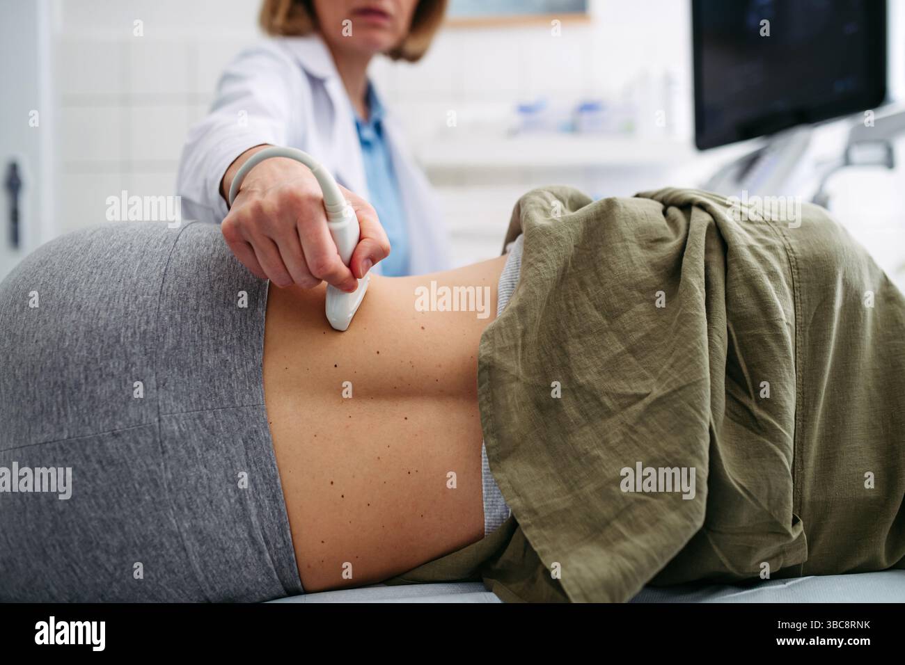 Medical examination with ultrasound probe on lower back Stock Photo - Alamy