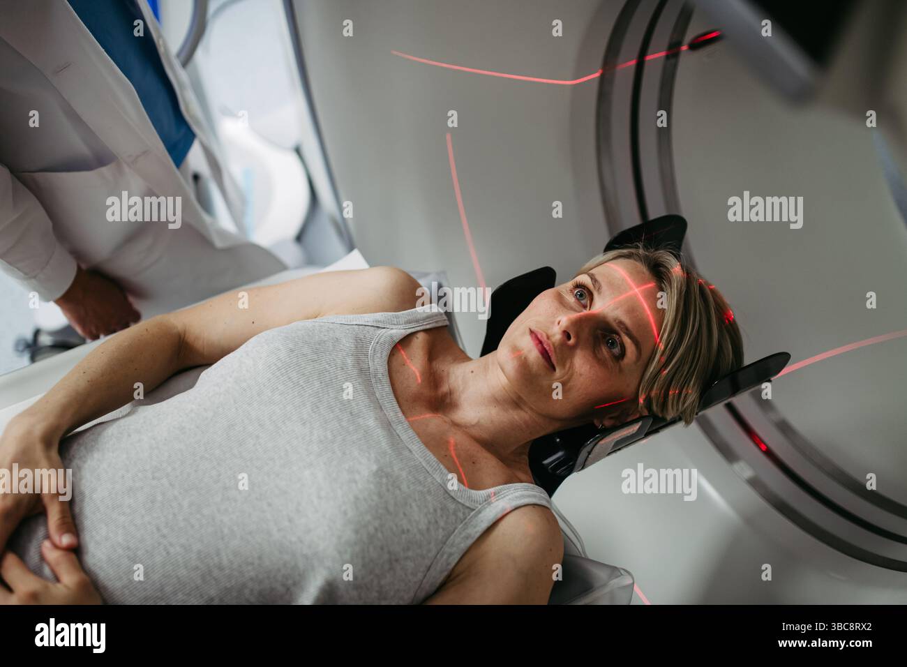 Patient positioned for head scan with laser alignment in CT scanner ...