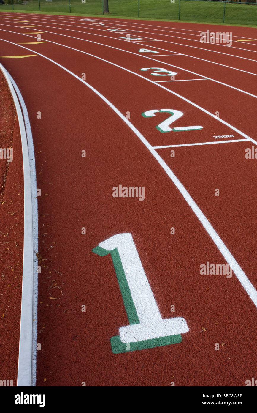Red running tracks with staggered lane numbers from one to eight Stock ...