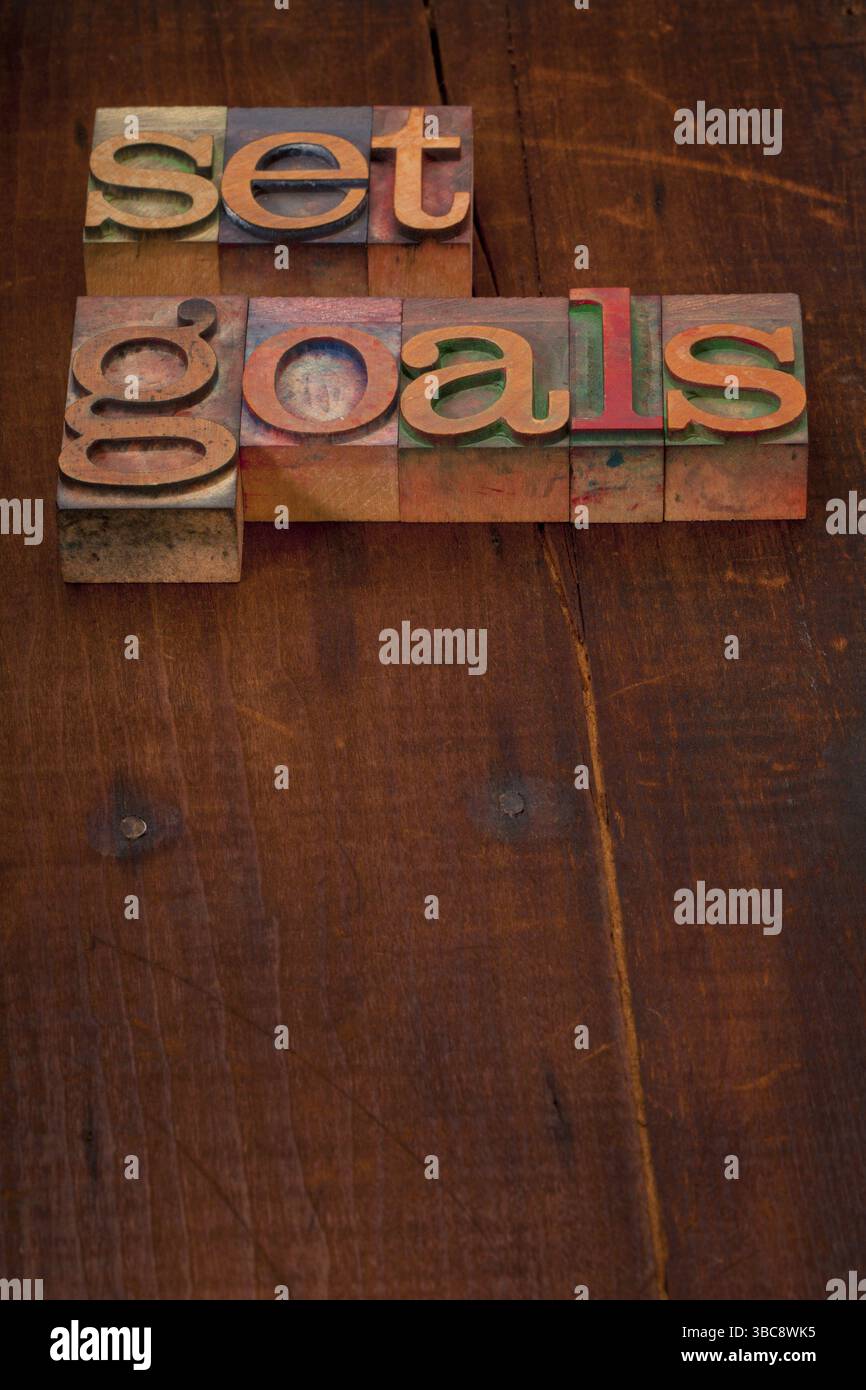 Set goals - text in vintage wooden letterpress printing blocks against ...