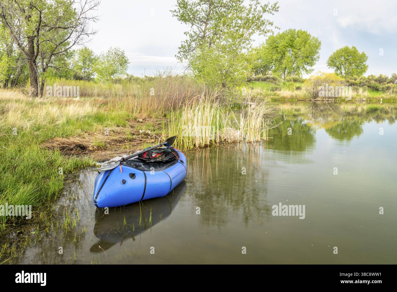 A blue pacraft (one-person light raft used for expedition or adventure ...