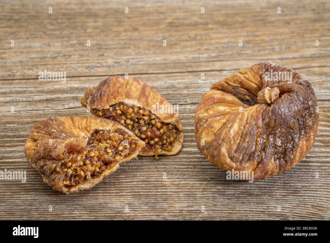 Dried Turkish figs on a grained wood background Stock Photo - Alamy