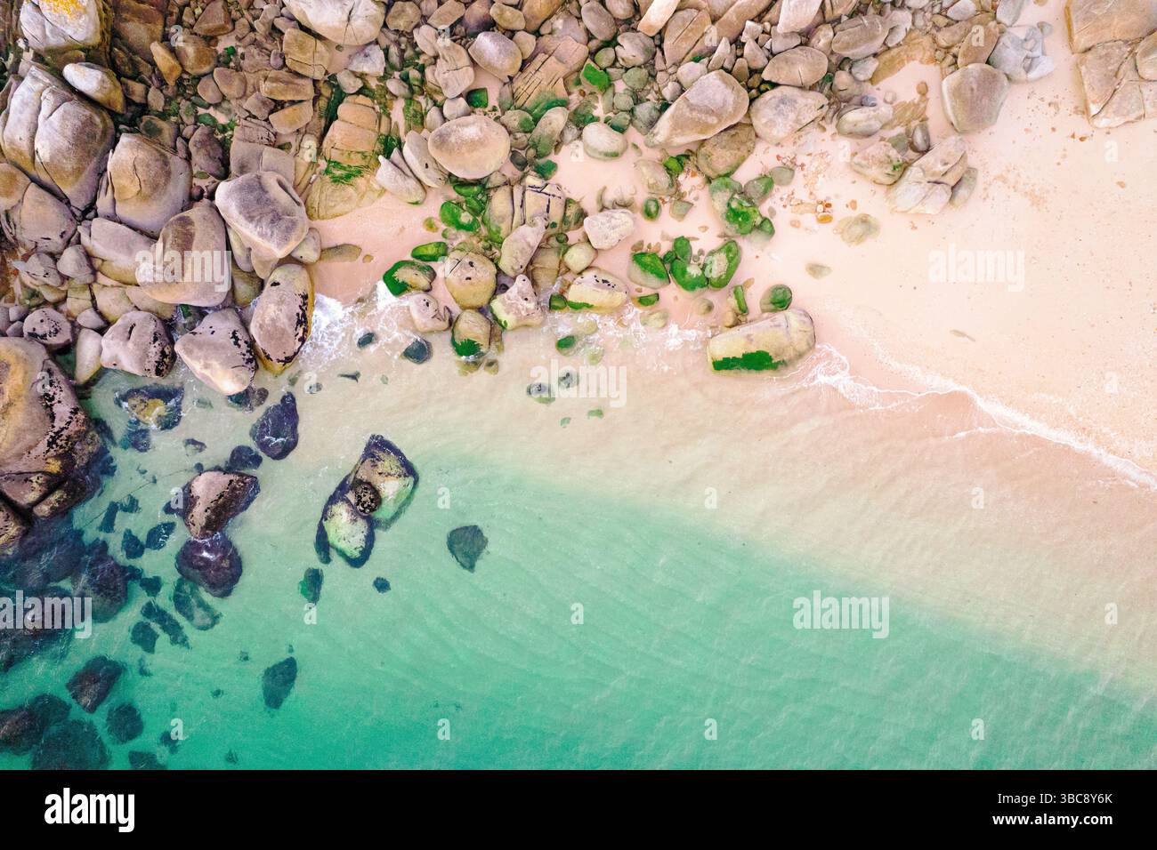 aerial perspective of clear ocean with visible underwater rocks, top ...