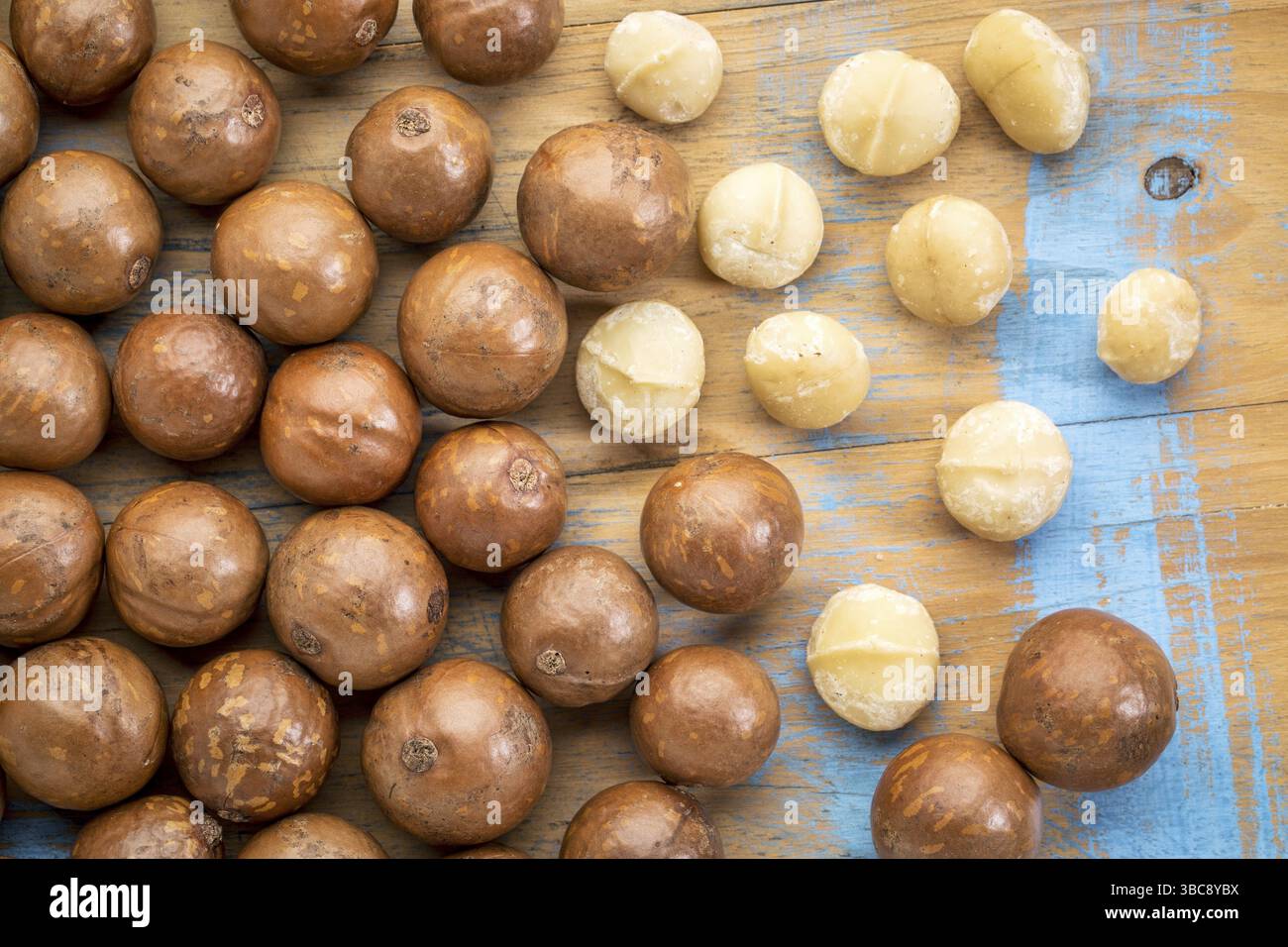 Macadamia nuts in shells and without on a rustic grunge wood - top view ...