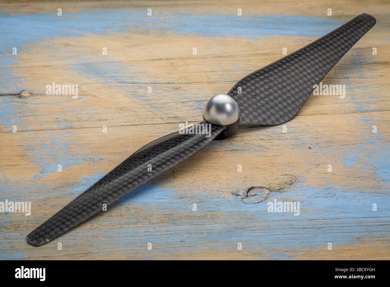 Carbon fiber drone propeller against grunge wood Stock Photo - Alamy