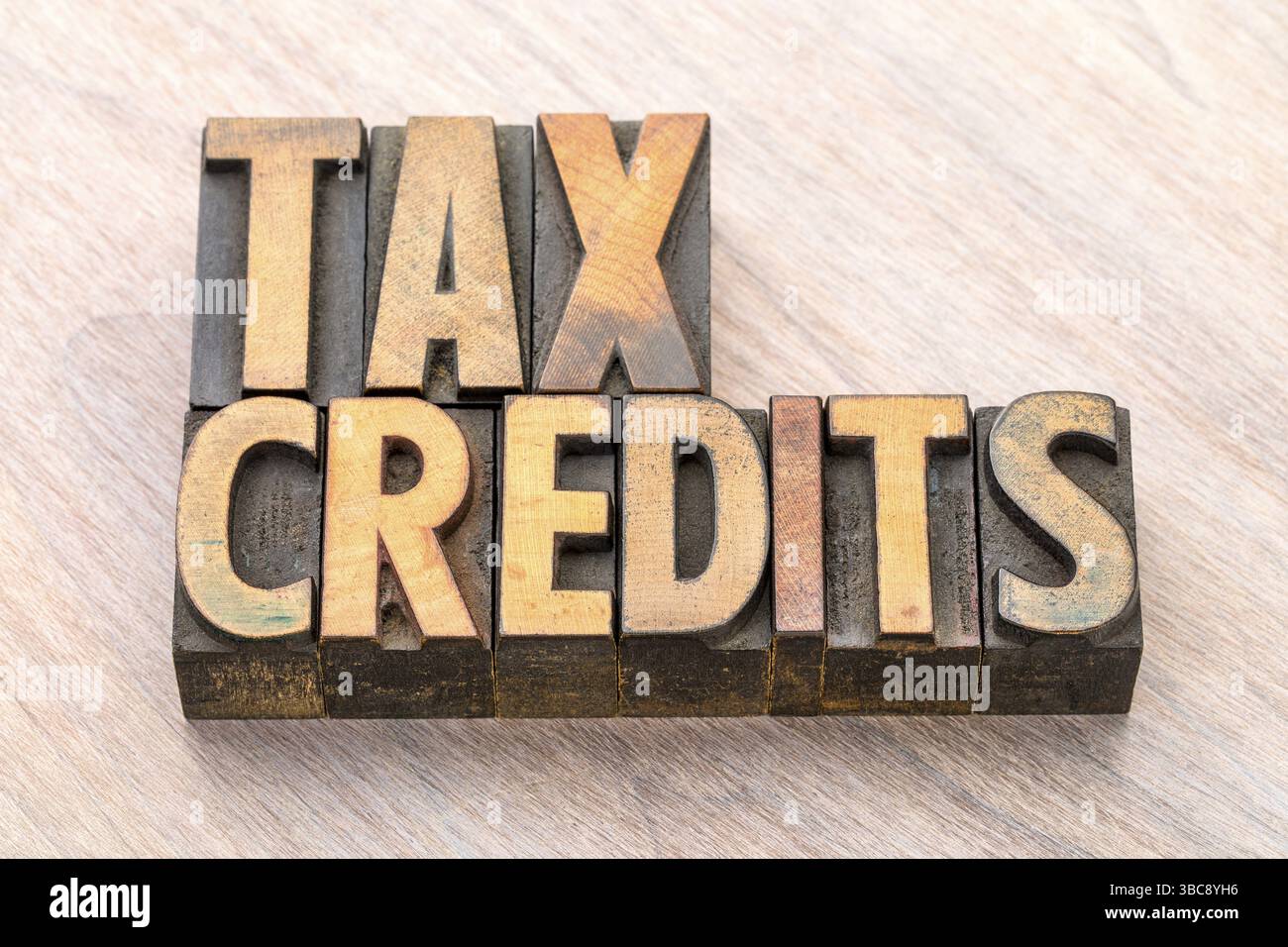 Tax credits word abstract in letterpress wood type against grained wood ...