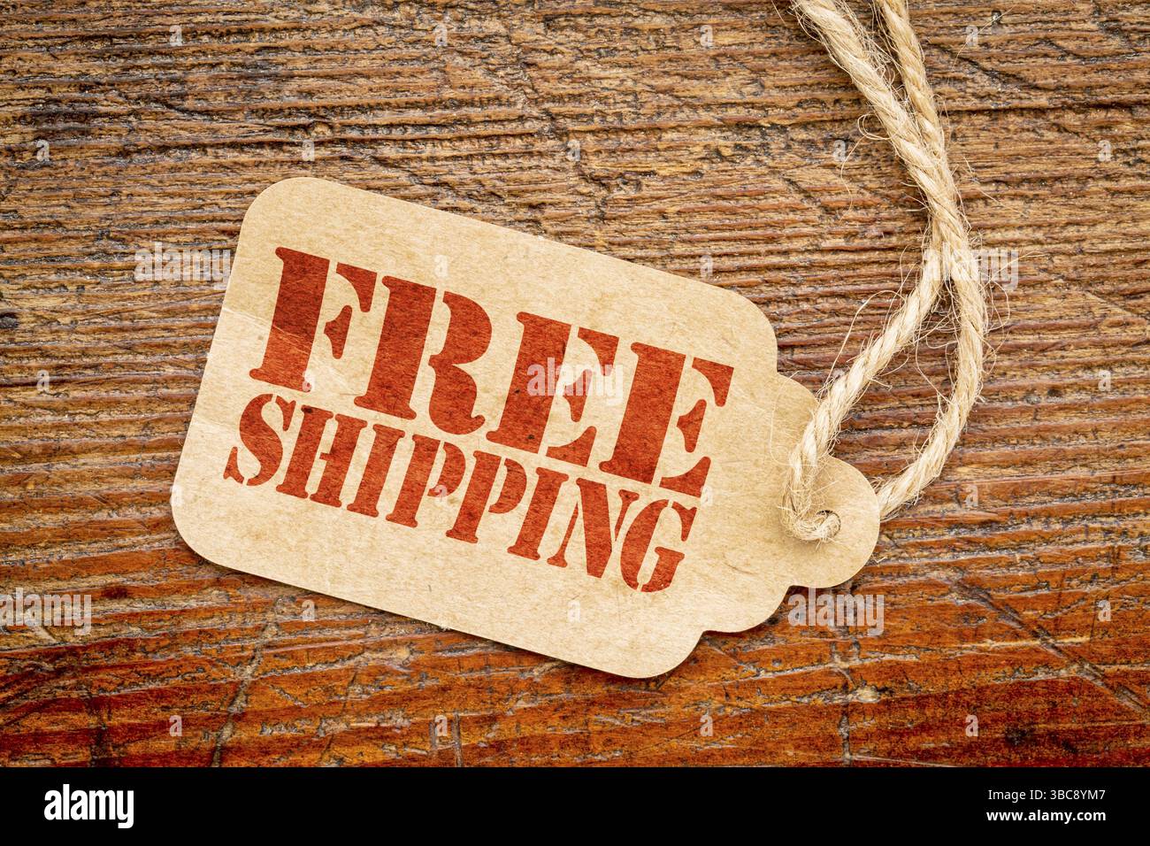 Free shipping sign - a paper price tag against rustic red painted barn ...