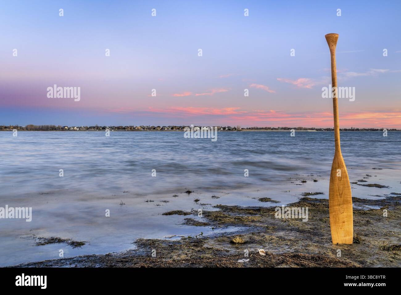 Canoe paddle on a lake shore at dusk Stock Photo - Alamy