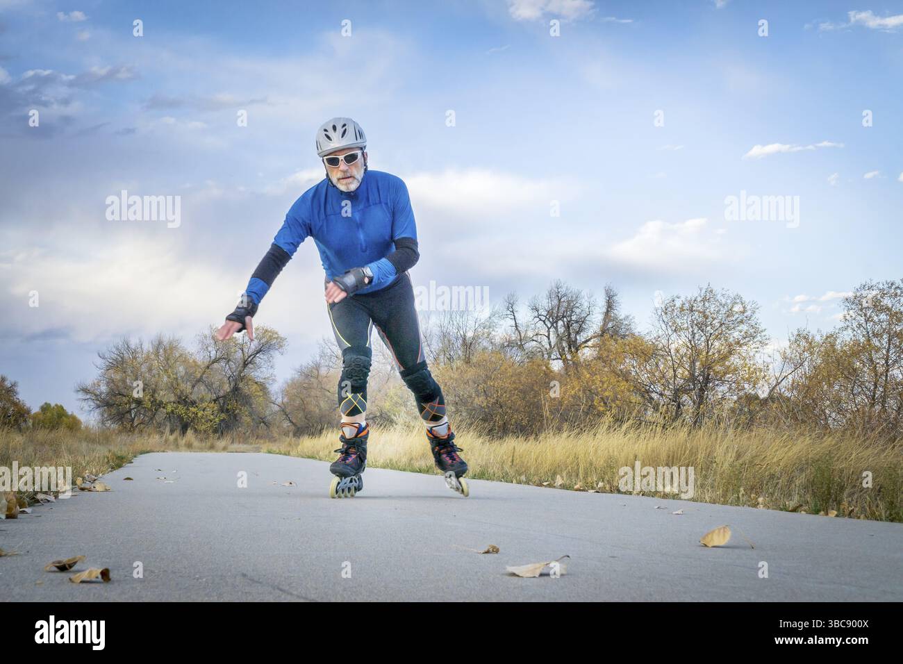 Senior athletic male inline skating on the Poudre RIver Trail in ...