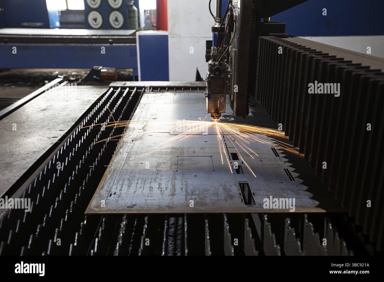 Cutting metal. Laser cutting machine processing sheet metal with flying ...