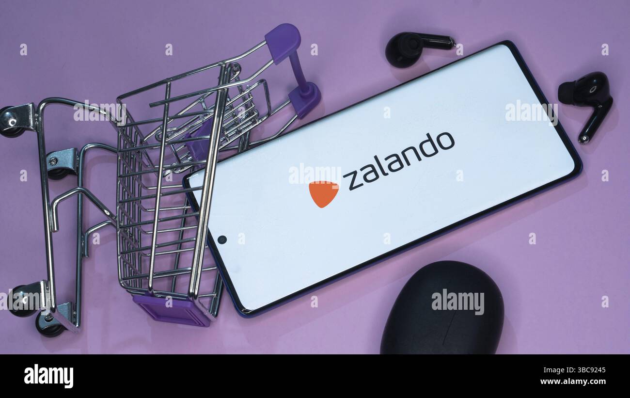 Zalando logo displayed on a smartphone with a shopping cart, headphones ...