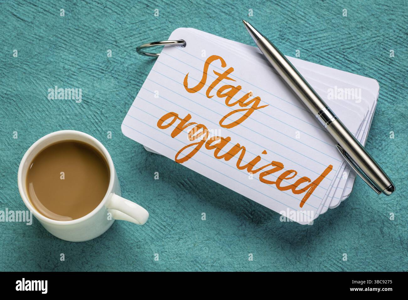Stay organized - reminder on a stack of index cards with a cup of ...