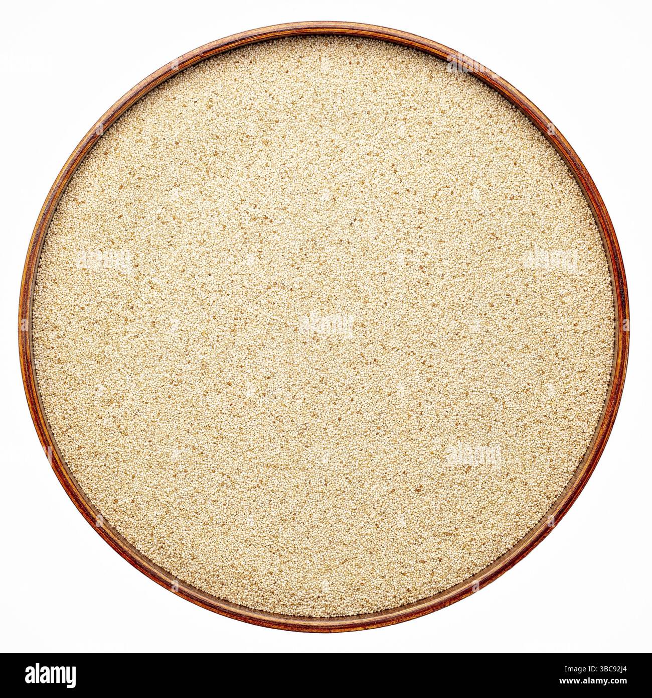 Gluten free ivory teff grain in a round wooden tray isolated on white ...