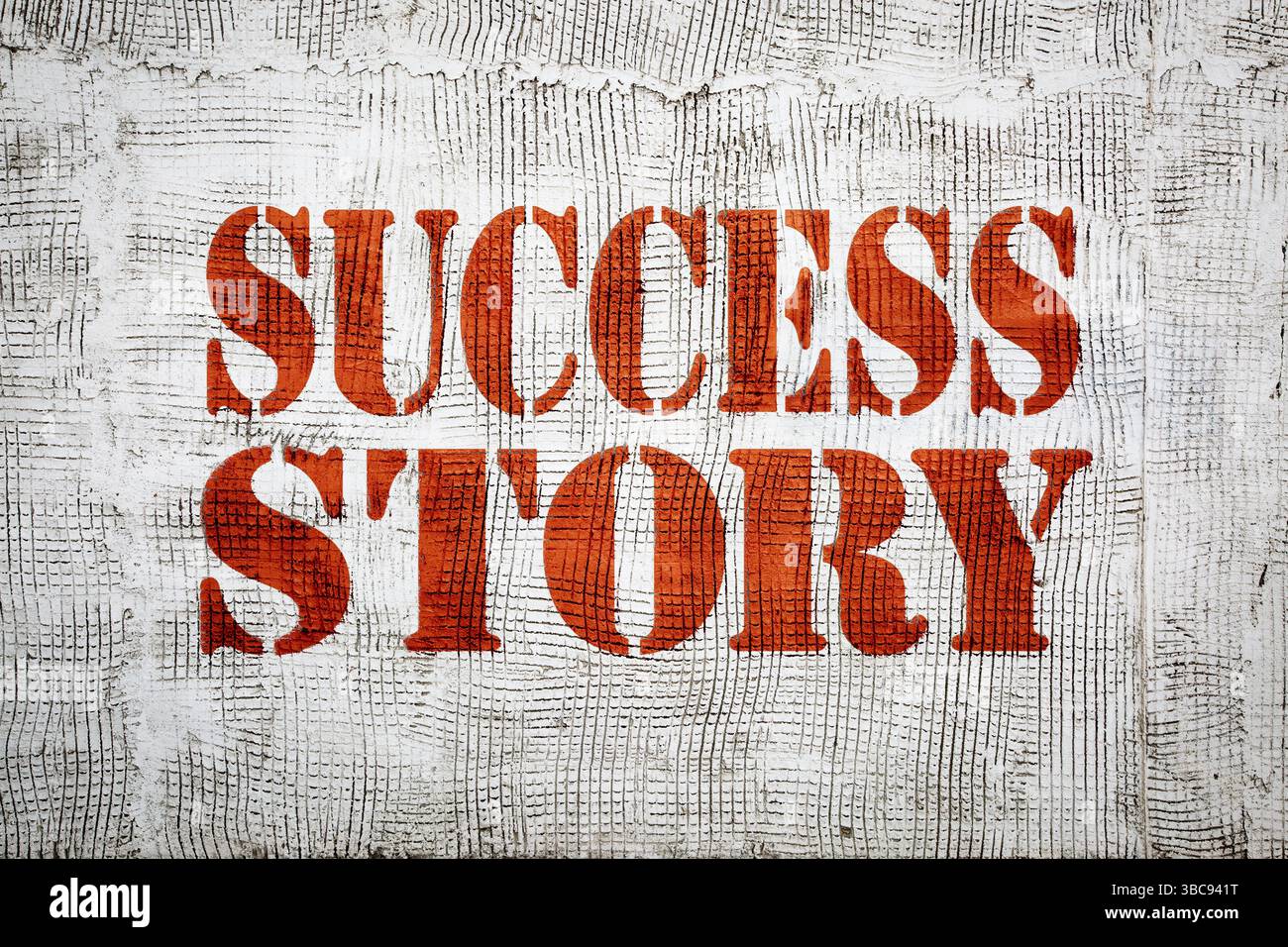 Success story sign painted in stencil font on an old, grunge stucco ...