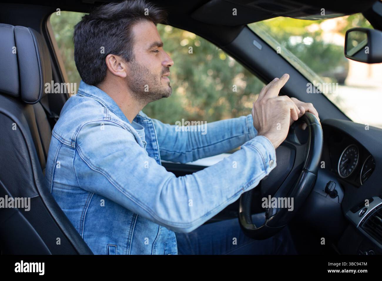 the upset driver man in the car discontent Stock Photo - Alamy