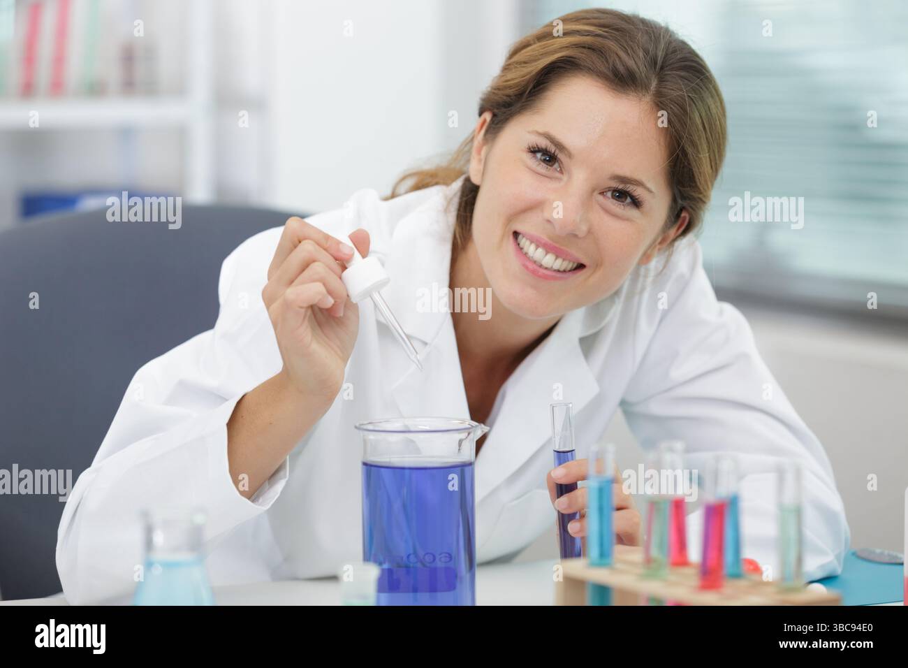 happy scientist with glass flask Stock Photo - Alamy
