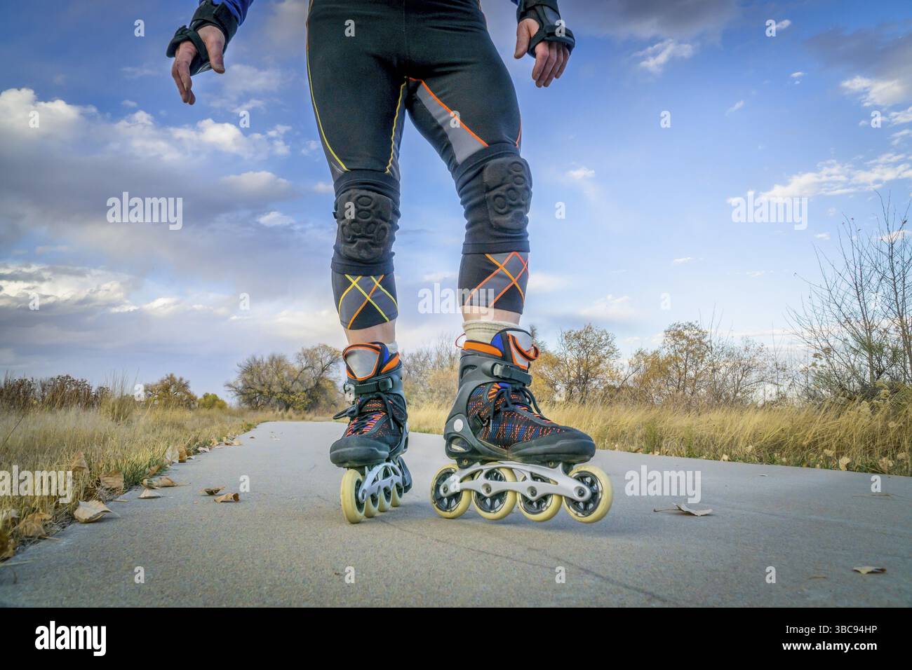 Fitness inline skater legs on paved bike trail in Colorado fall scenery ...