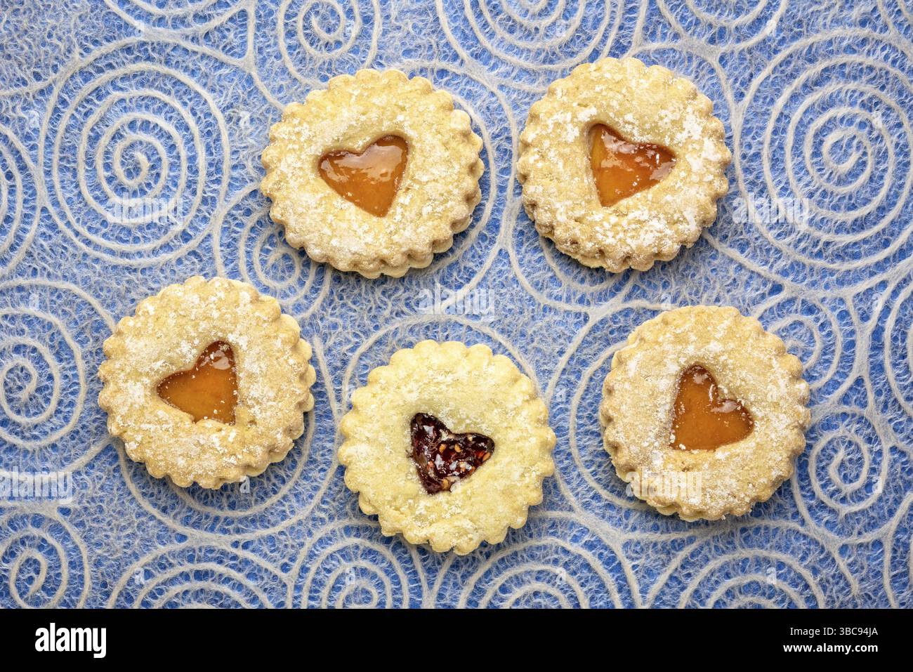 Jam heart biscuits on Japanese lace paper with a spiral pattern, top ...