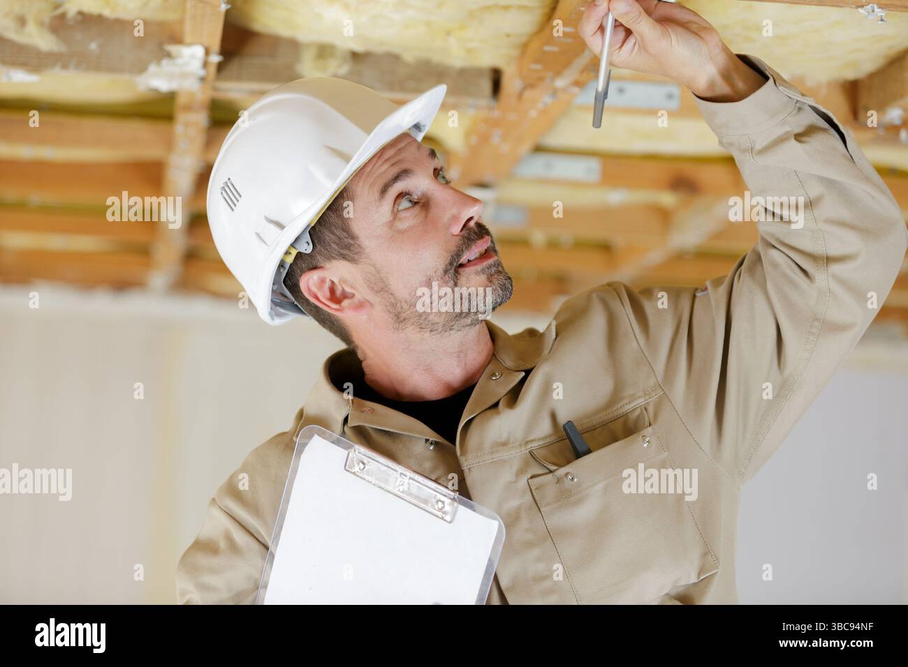 constructor engineer man marking a wood structure Stock Photo - Alamy
