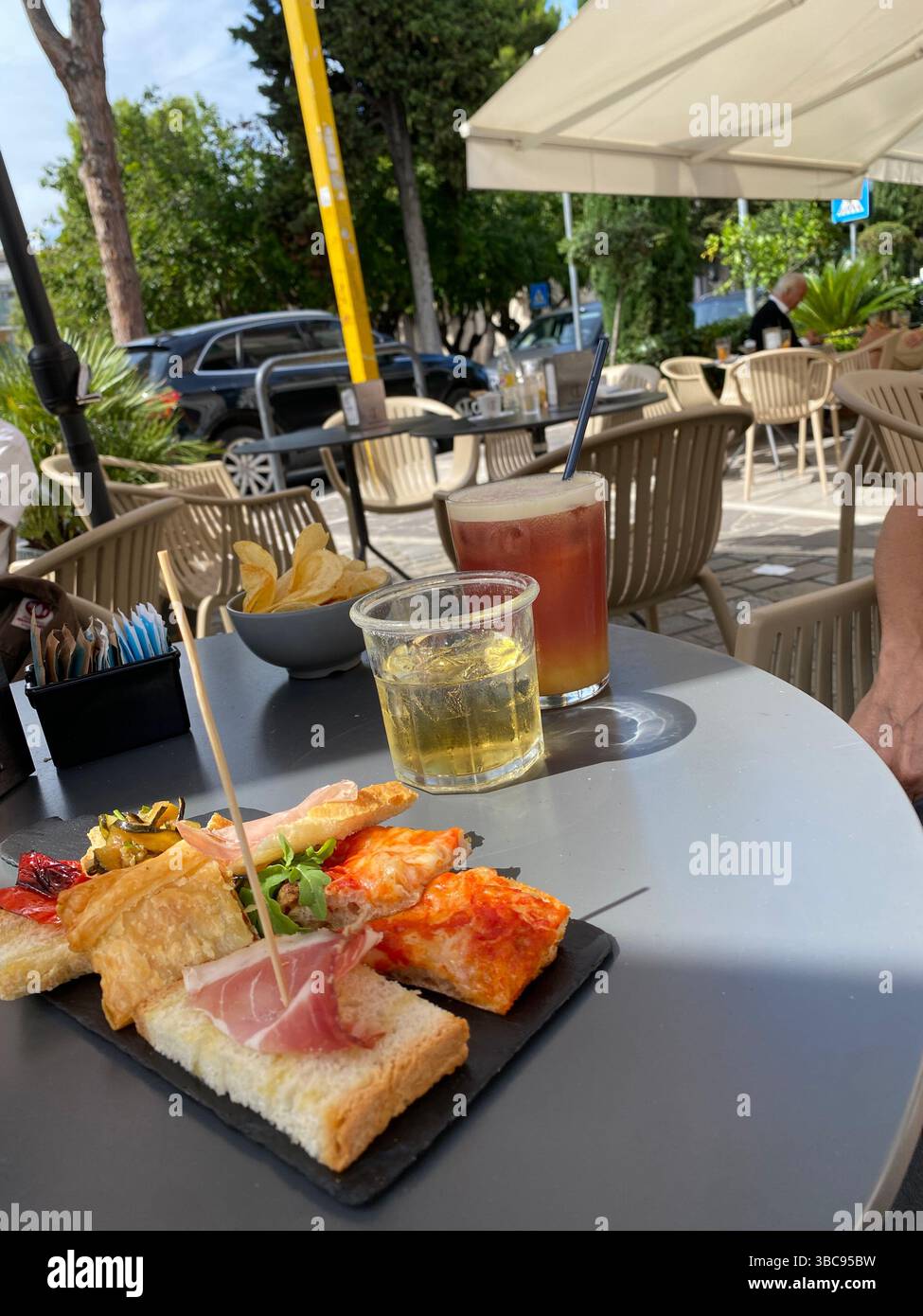 Delicious italian aperitivo with spritz, beer and various snacks in a ...