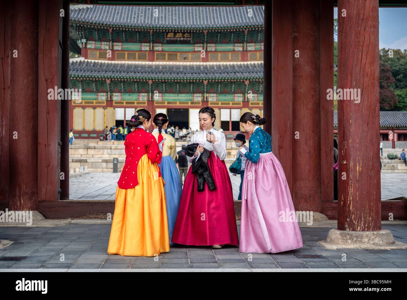 Tourists in traditional Korean Hanbok dresses visit Changdeokgung royal ...