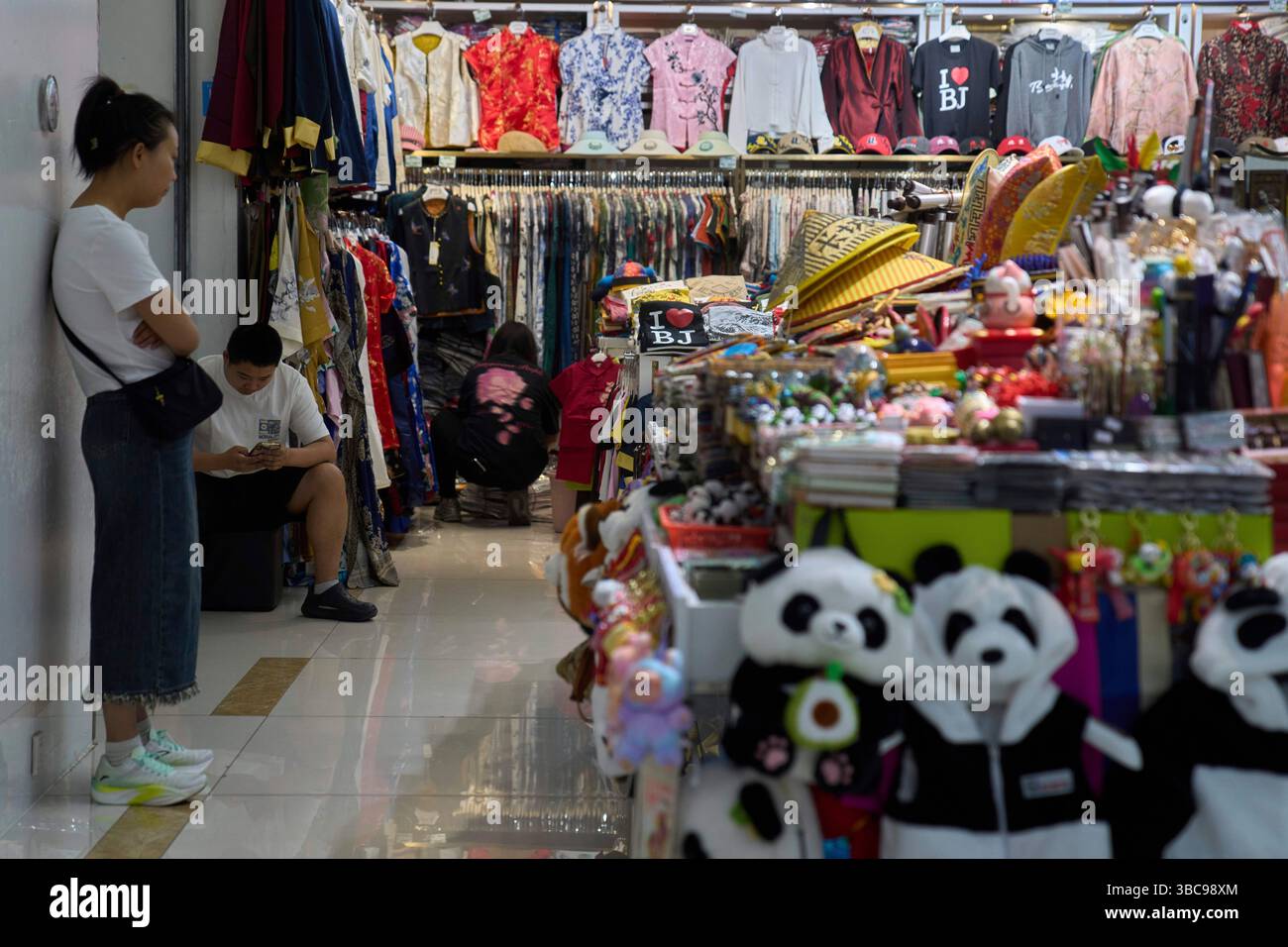 Vendors wait for customers at their store selling clothing and ...