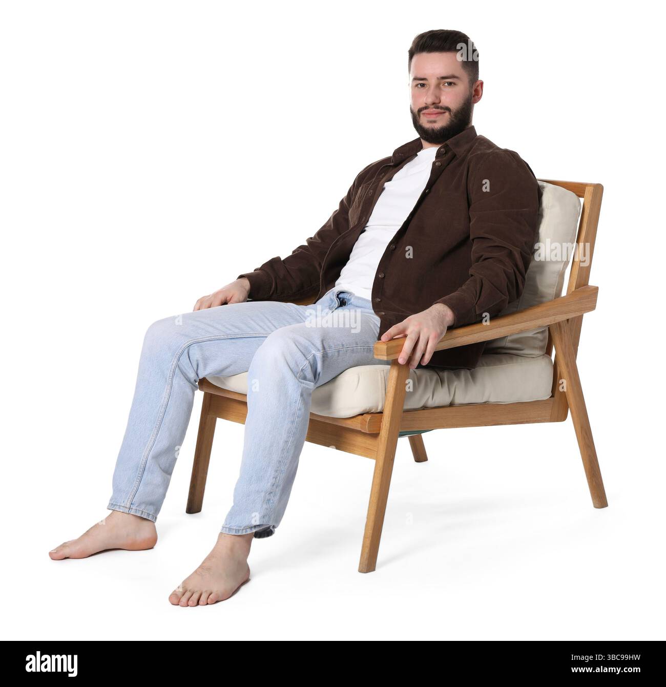 Handsome man relaxing on chair against white background Stock Photo - Alamy