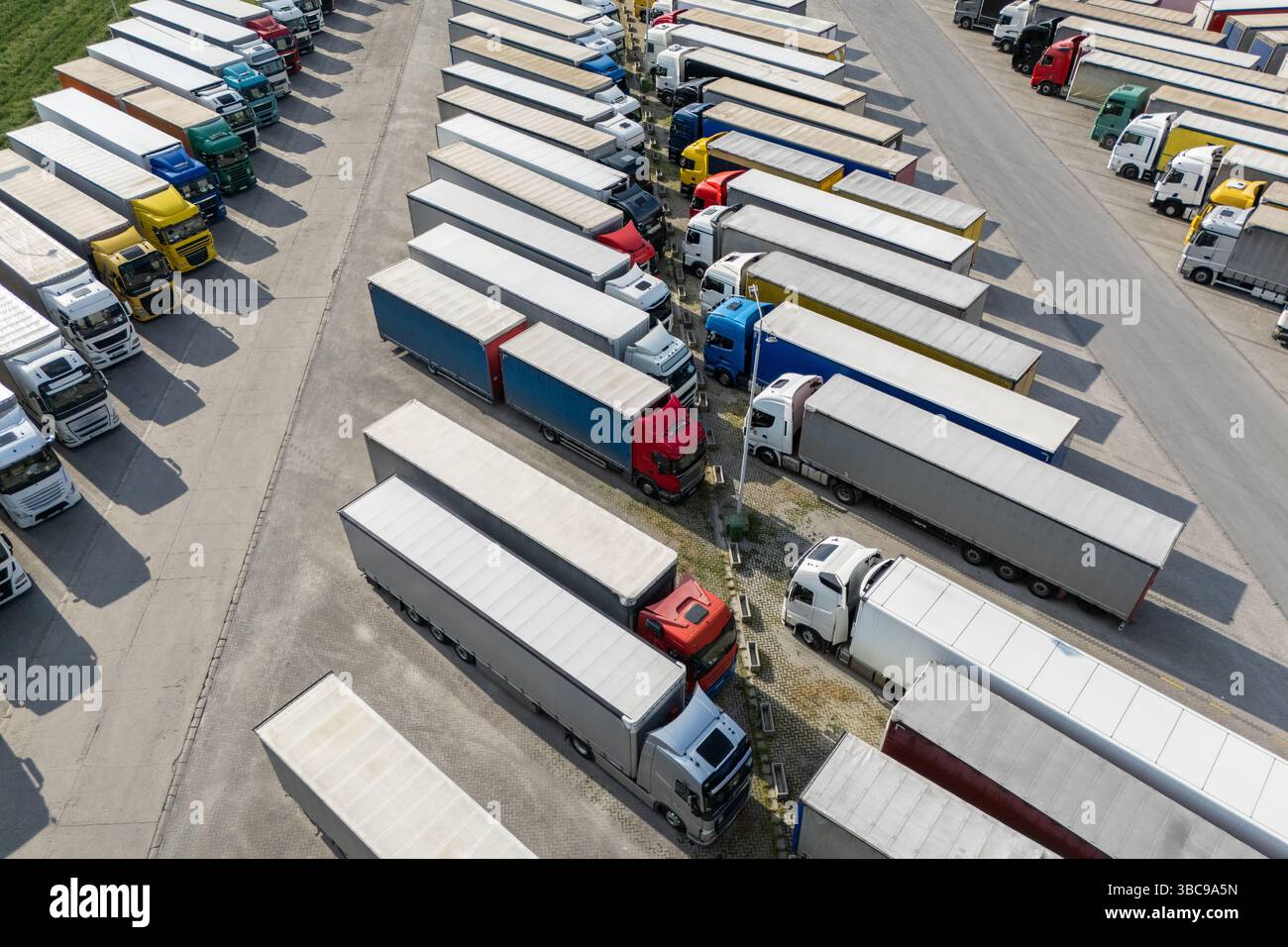 Aerial view of a large truck parking lot at a logistics hub, with ...
