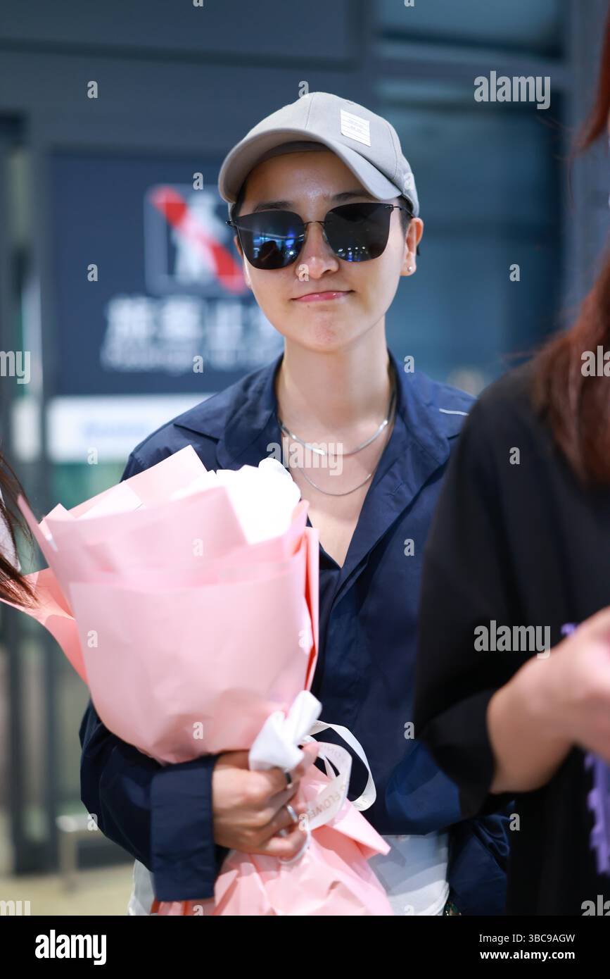 Chinese singer Jiang Yiqiao appears at the airport in Shanghai, China ...