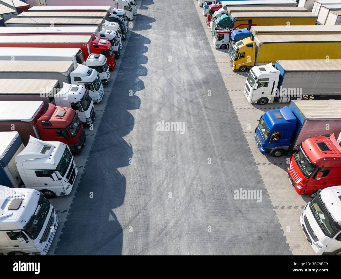 Aerial view of a large truck parking lot at a logistics hub, with ...