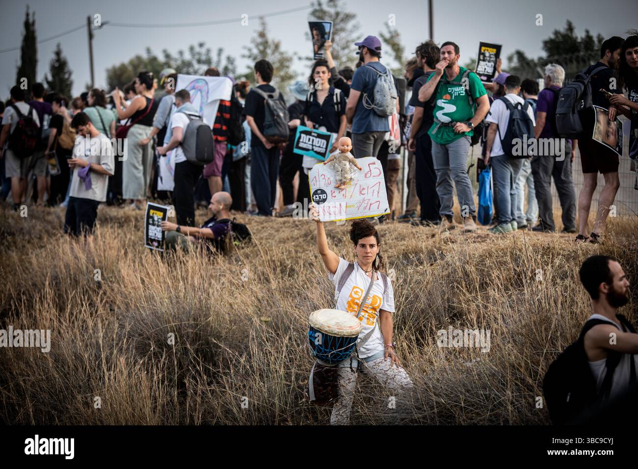 A peace activist holds up a sign that reads in Hebrew Ò all children ...