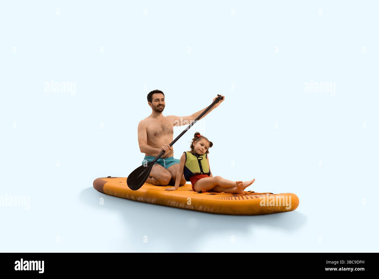 Father sitting on sup board and paddleboarding with daughter sitting ...