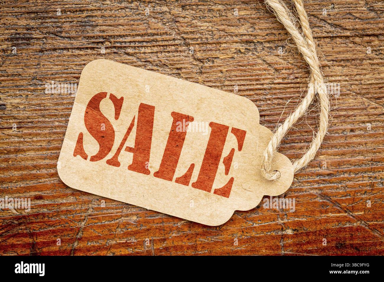 Sale sign a paper price tag against rustic red painted barn wood ...