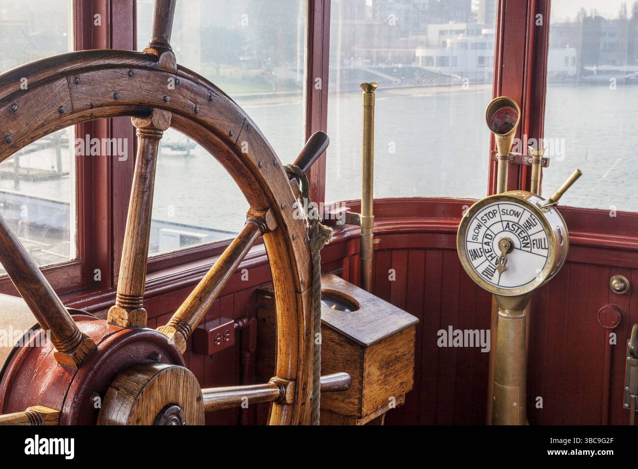 Steering wheel and engine controls (telegraph) on a vintage ship bridge ...