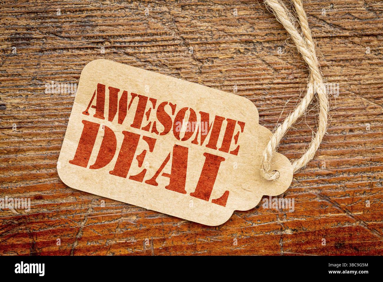 Awesome deal sign - red stencil text on a paper price tag against ...