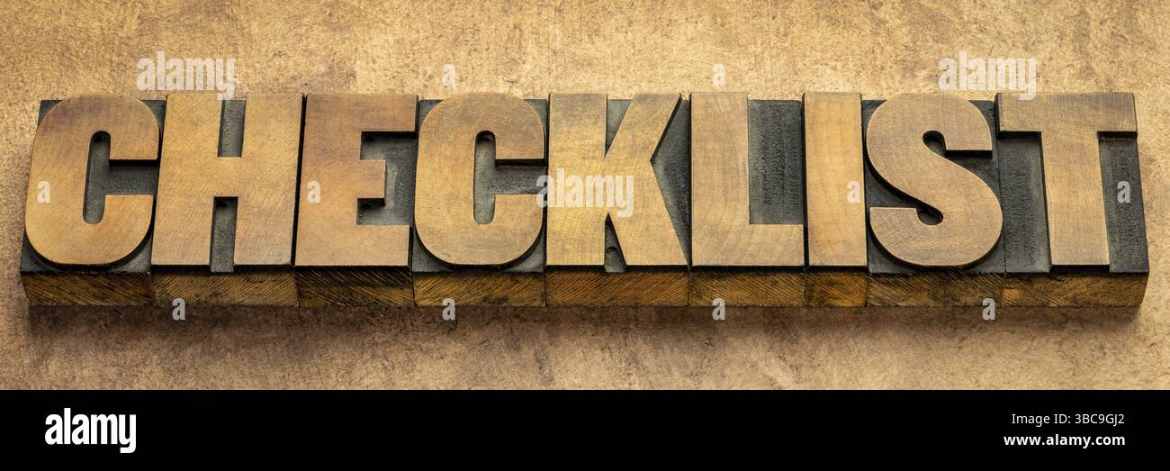 Checklist word in vintage letterpress wood type against handmade paper ...