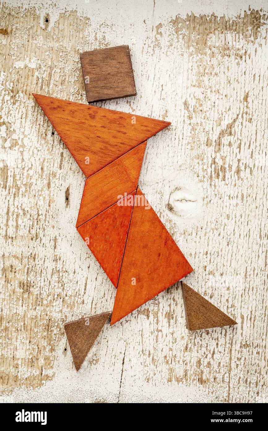 Abstract figure of a female dancer built from seven tangram wooden ...