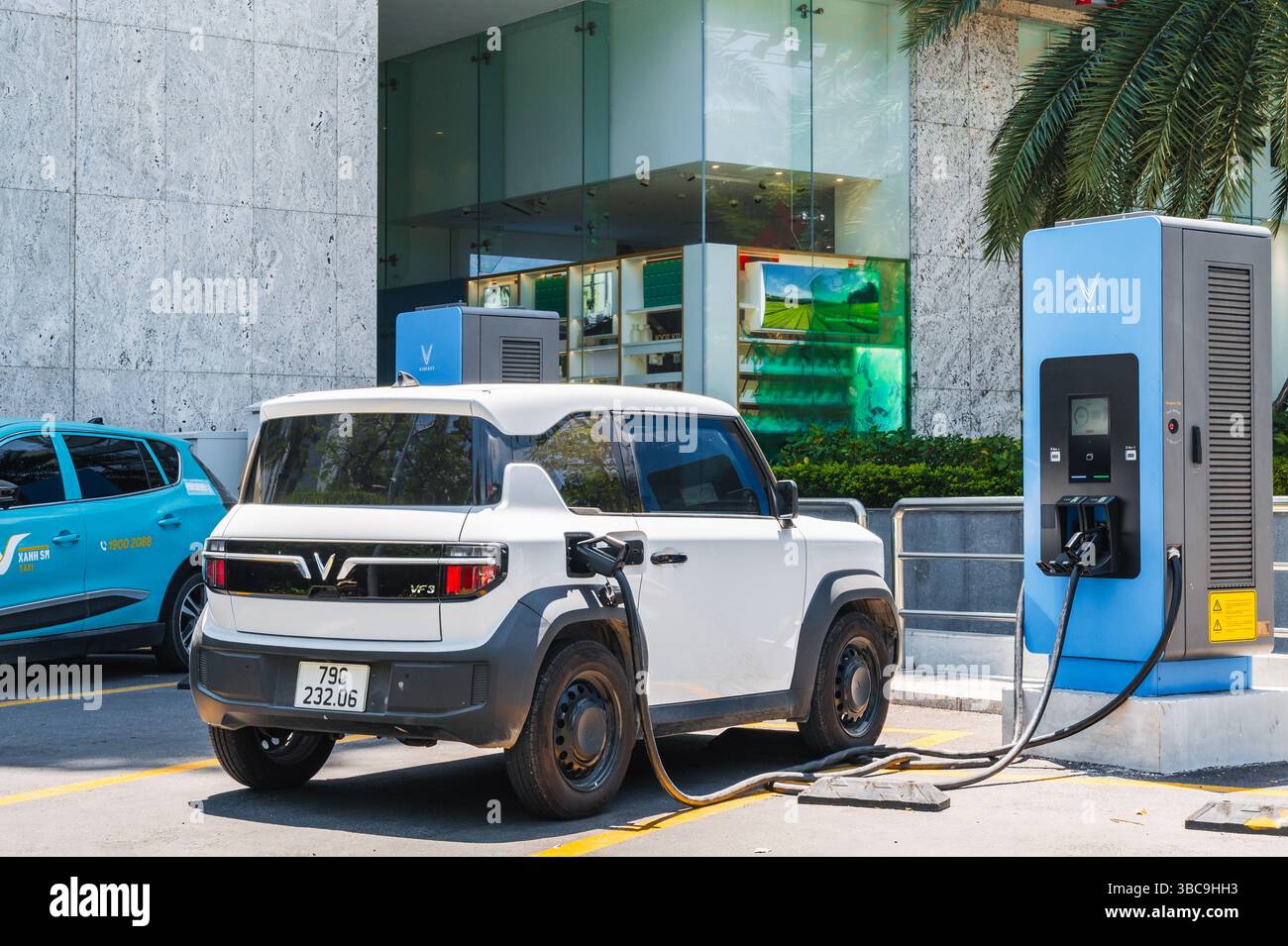 The VinFast car is parked at an electric gas station, next to the ...