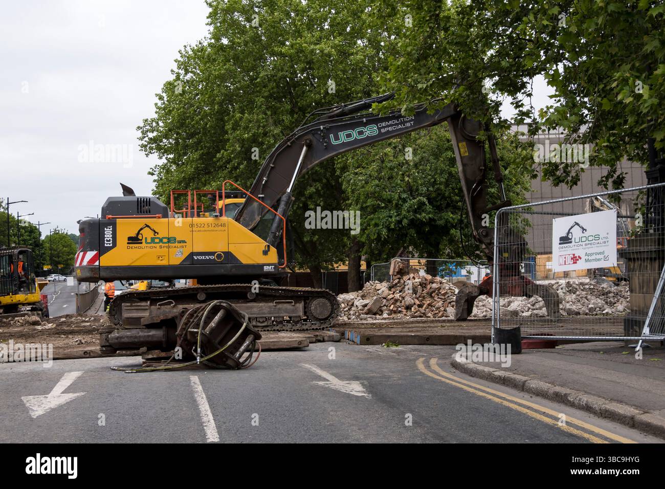 Heavy duty tracked grab and crusher machine at demolition site of ...