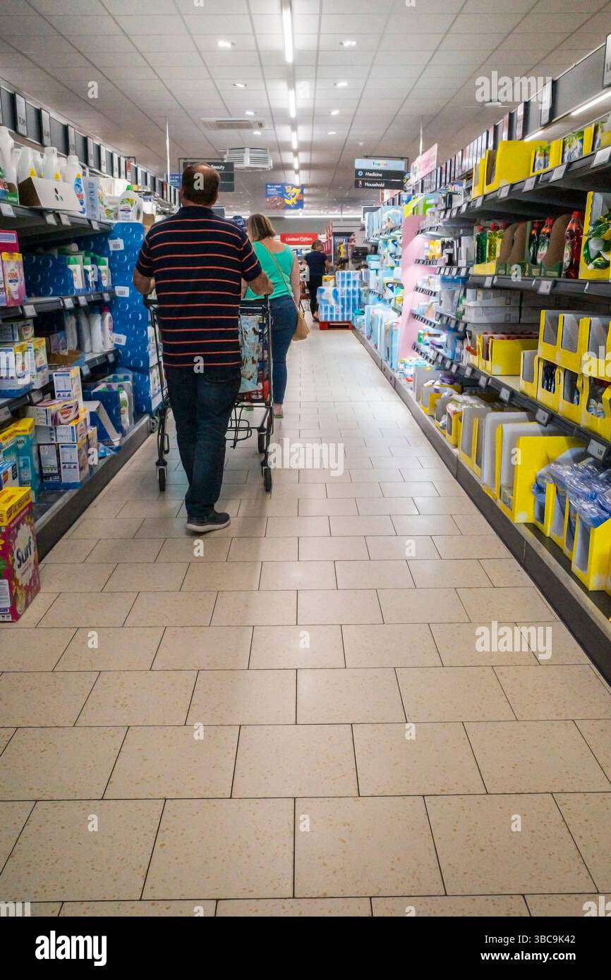 Shoppers customers people shopping inside a Lidl shop store in England ...