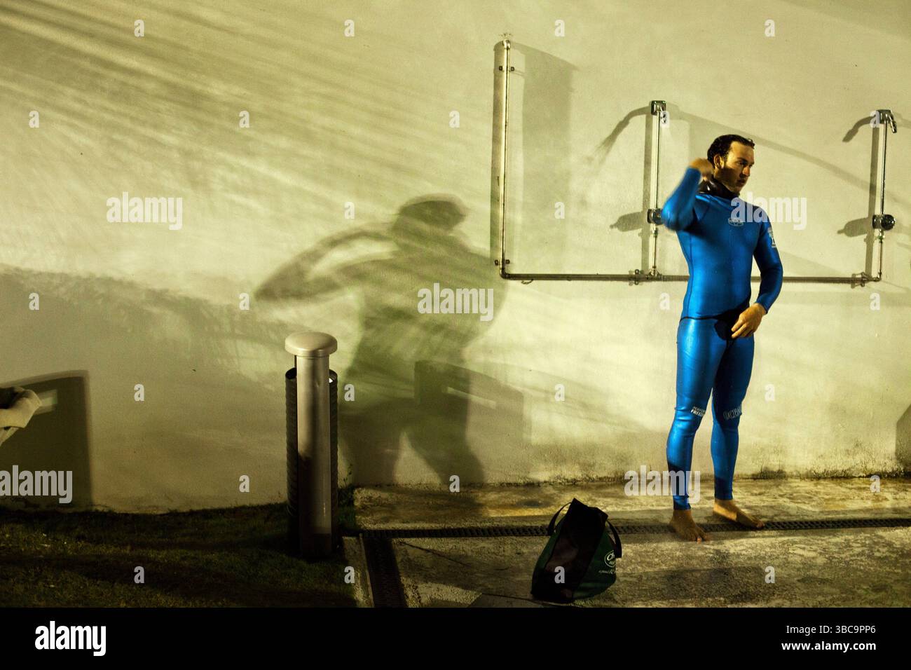 Grant Hogan, who has tattoos of shark gills on his rib cage, showers ...