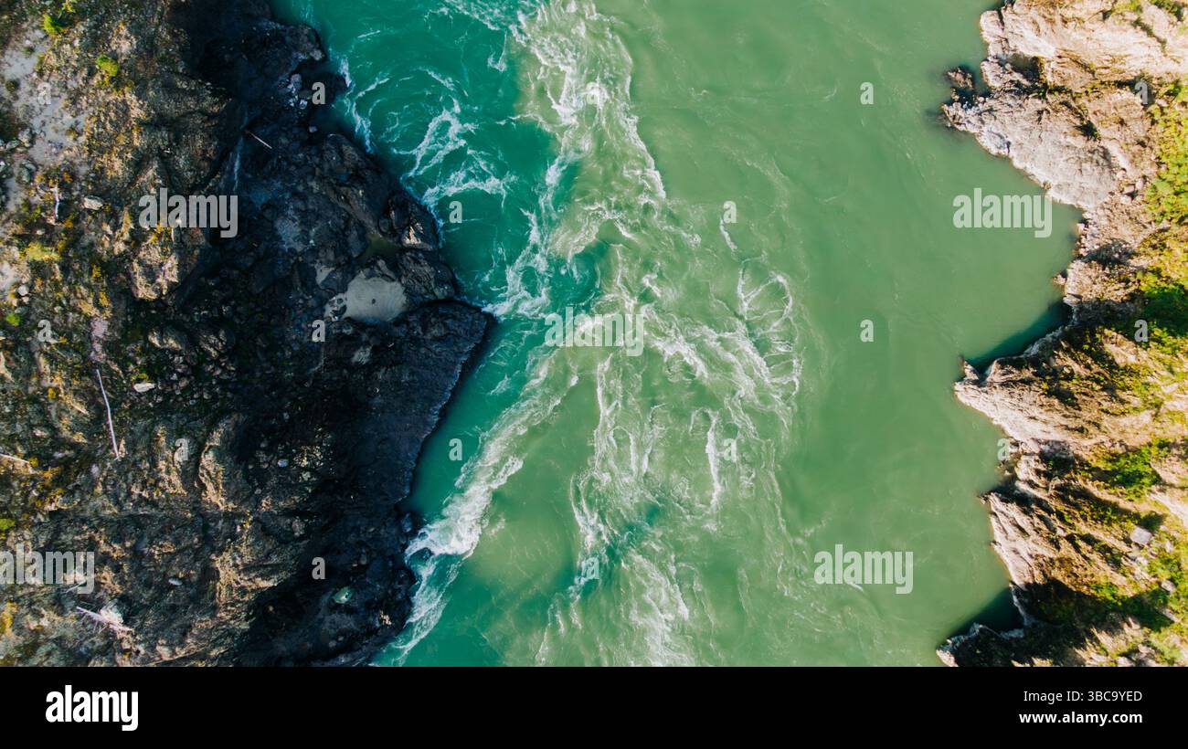 Two rivers with contrasting colors are merging together, creating ...