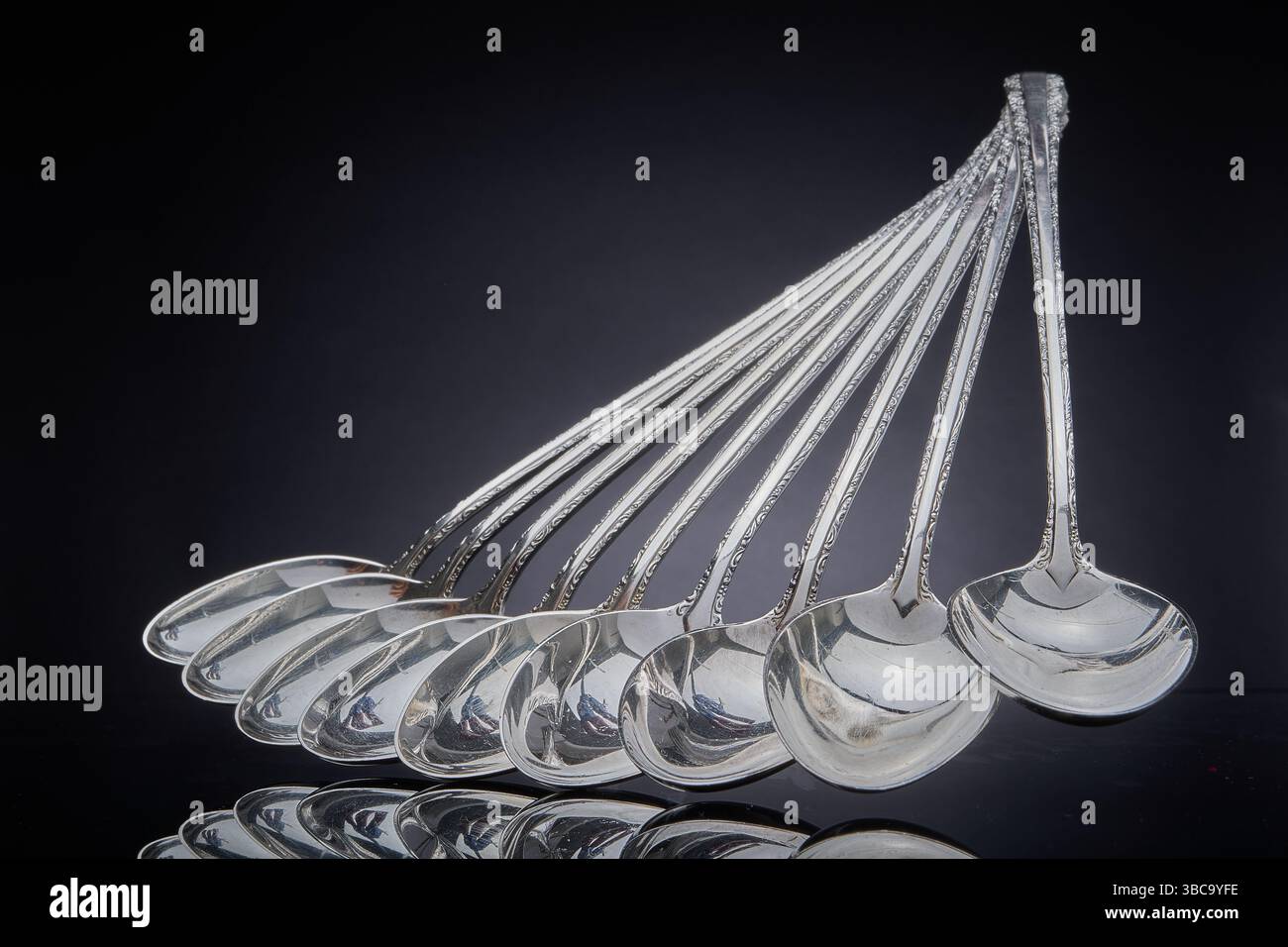 Collection of fanned out silver spoons Stock Photo - Alamy