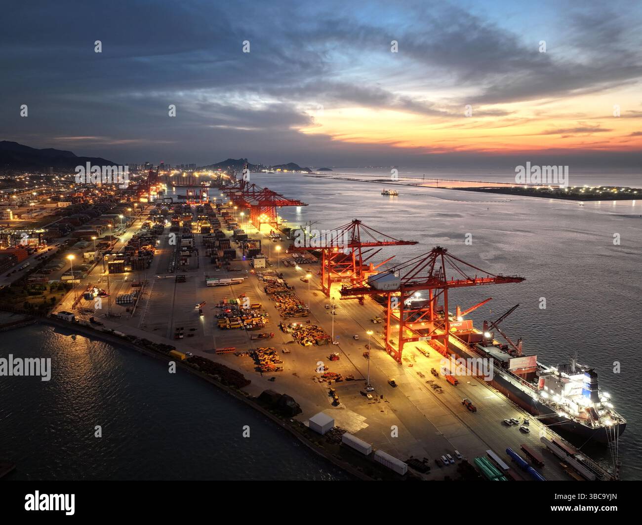 Aerial photo shows the container terminal of Lianyungang Port at night ...