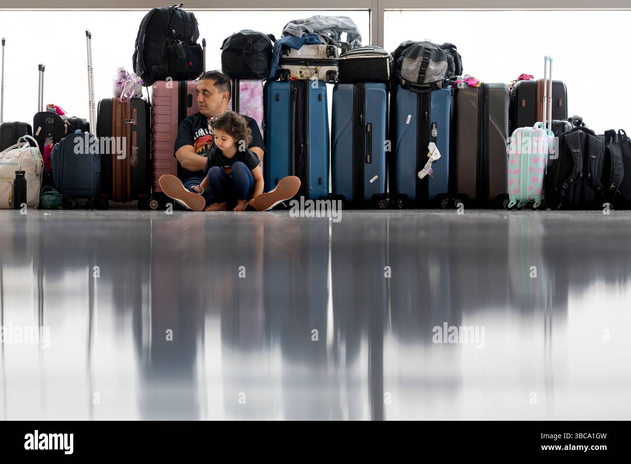 FILE - Samuel Tadros and his daughter Serenity 3, sit with the family's ...